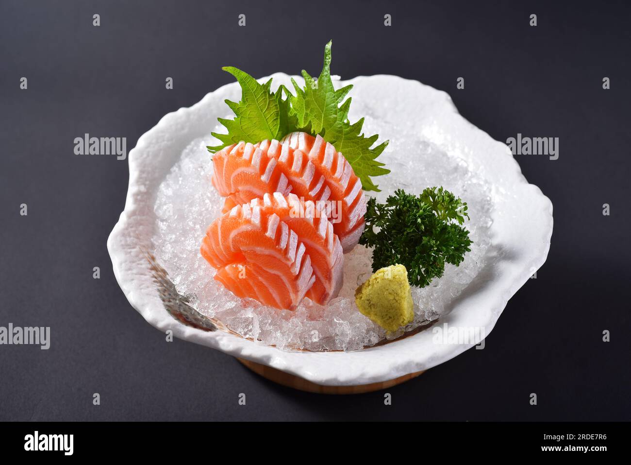 Salmon Sashimi with belly, Japanese buffet restaurant.Fresh salmon fillet on black plate salmon ...