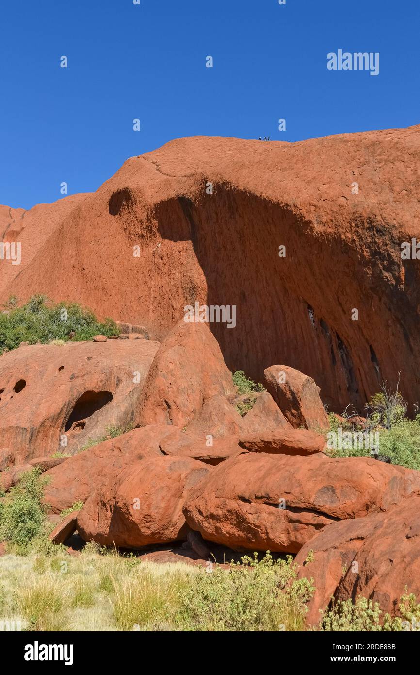 People climbing the Uluru, Ayers rock at Uluru Kata Tjuta National Park ...