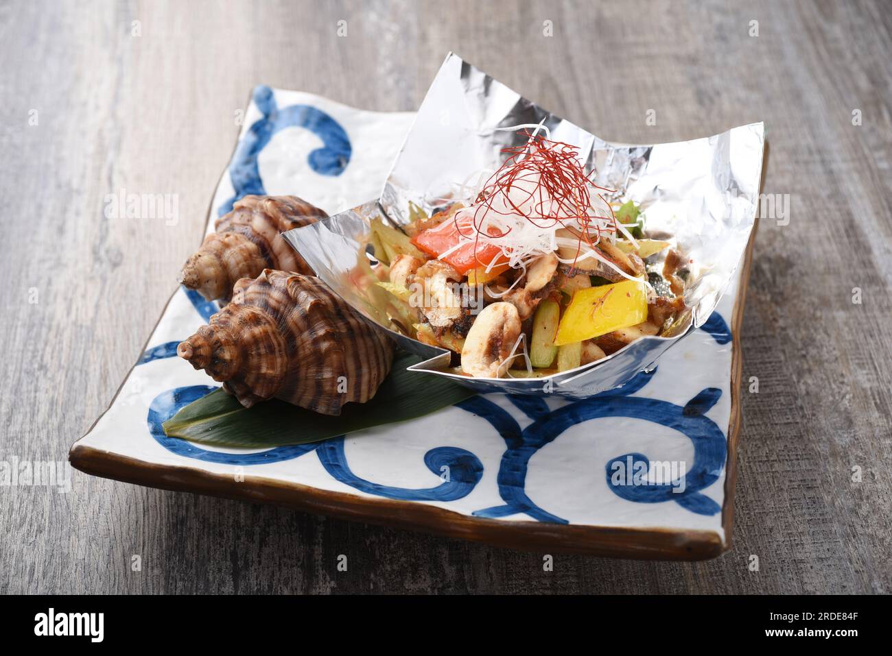 stir-fried sea snails slices, Japanese food Stock Photo - Alamy