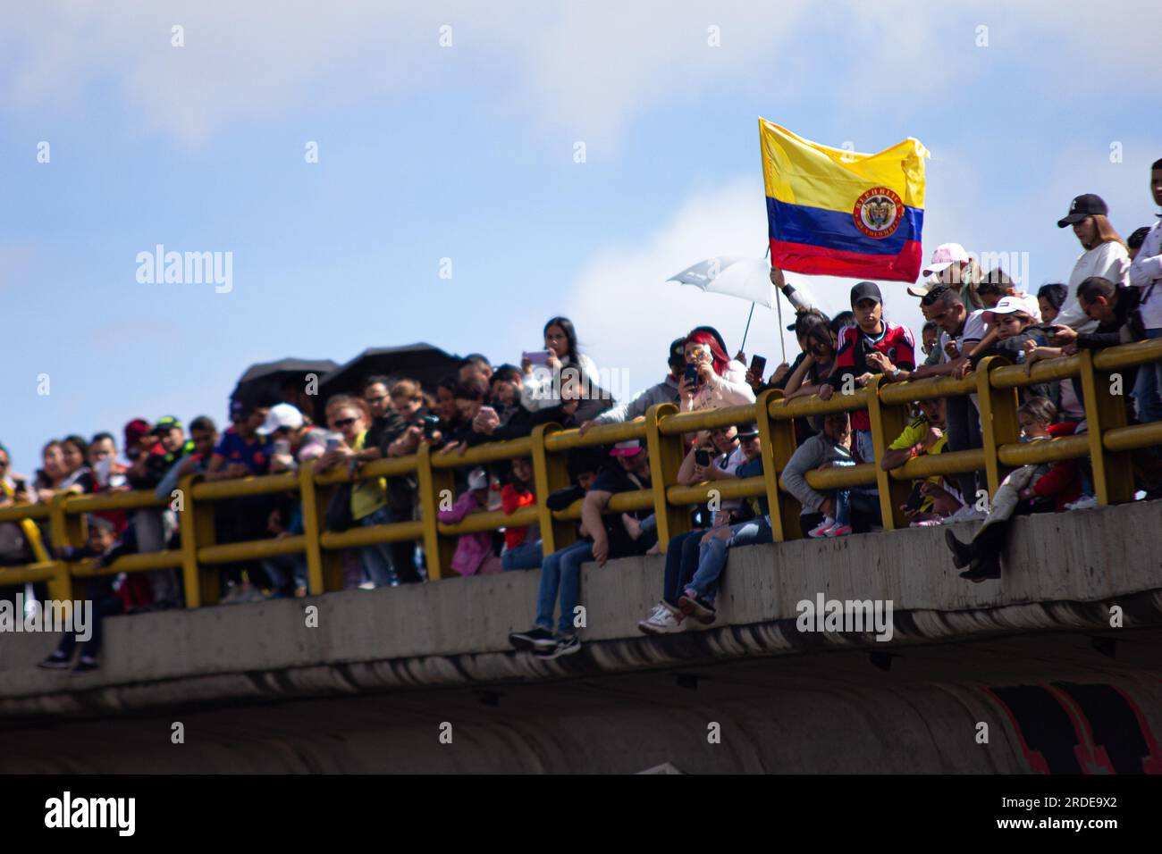 Bogota, Colombia. 20th July, 2023. Parade-viewers stand in a bridge and ...