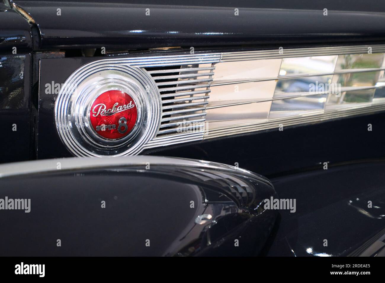 A close up, detail of a vintage black Packard car with red circle badge ...