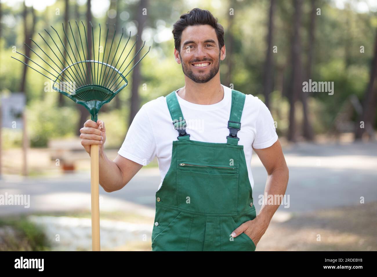 Man holding rake in lawn hi-res stock photography and images - Alamy