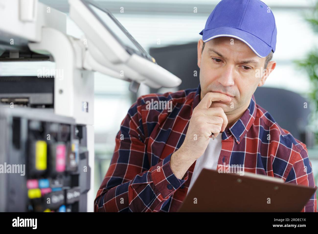 technician is checking and changing the printer equipment cartridges ...