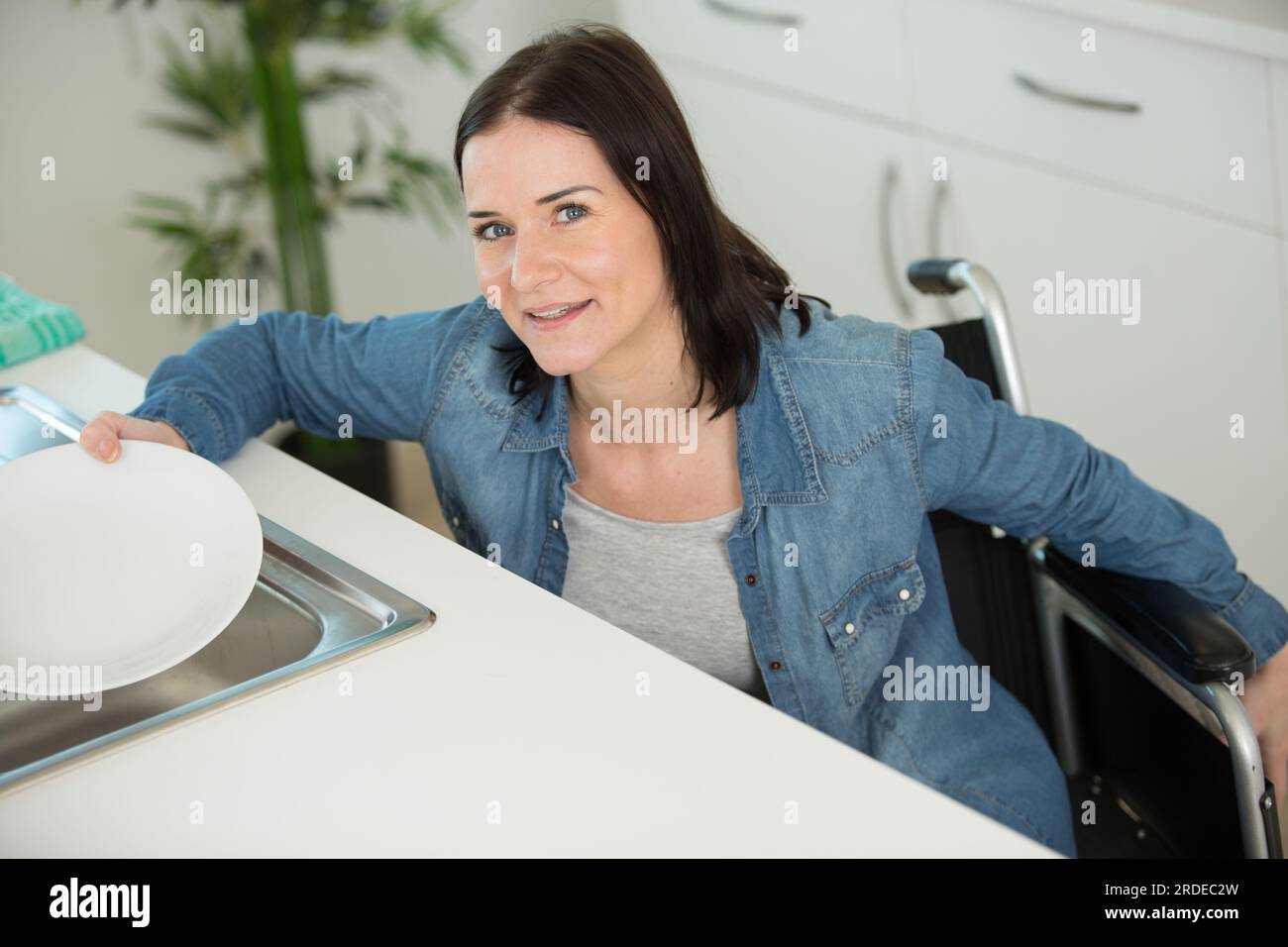 disabled woman doing house chores Stock Photo - Alamy