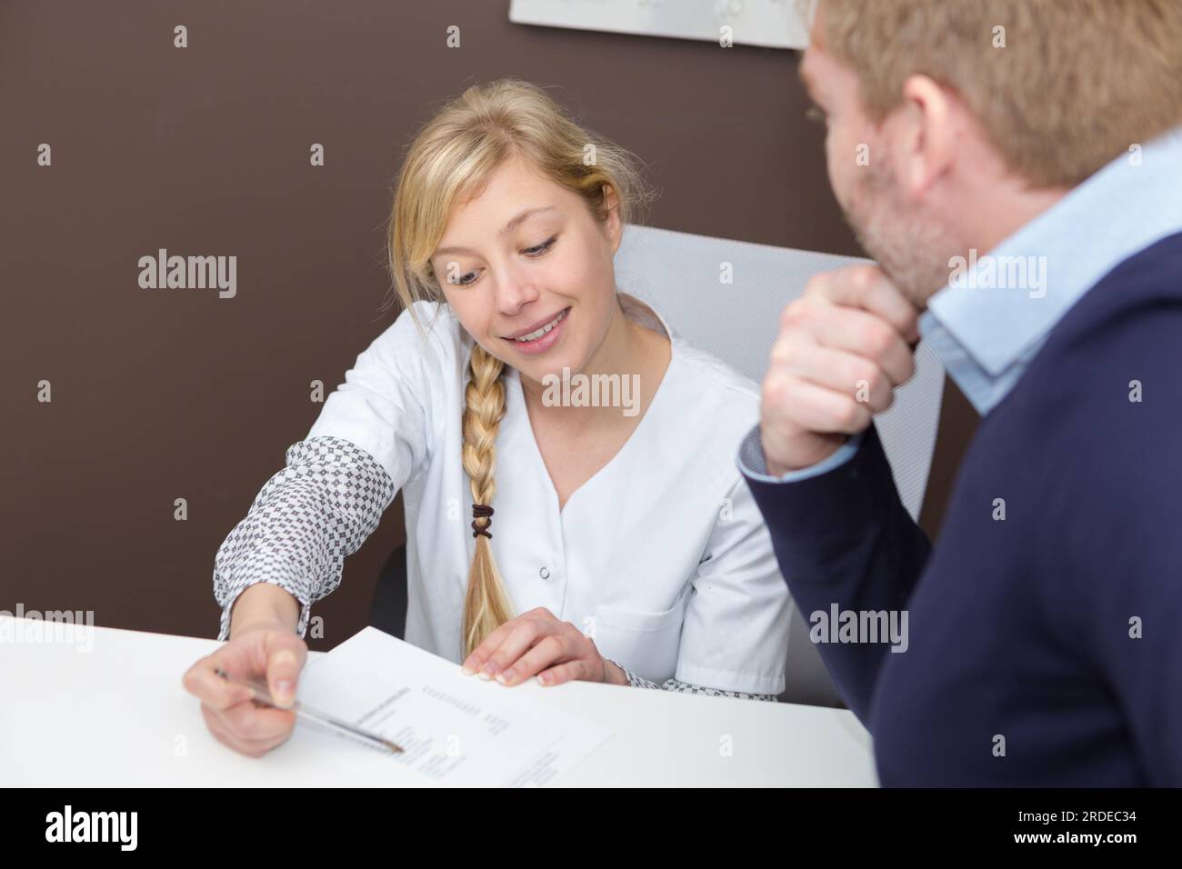 therapist asking a patient to sign a typed form Stock Photo - Alamy therapist asking a patient to sign a typed form Stock Photo - Alamy