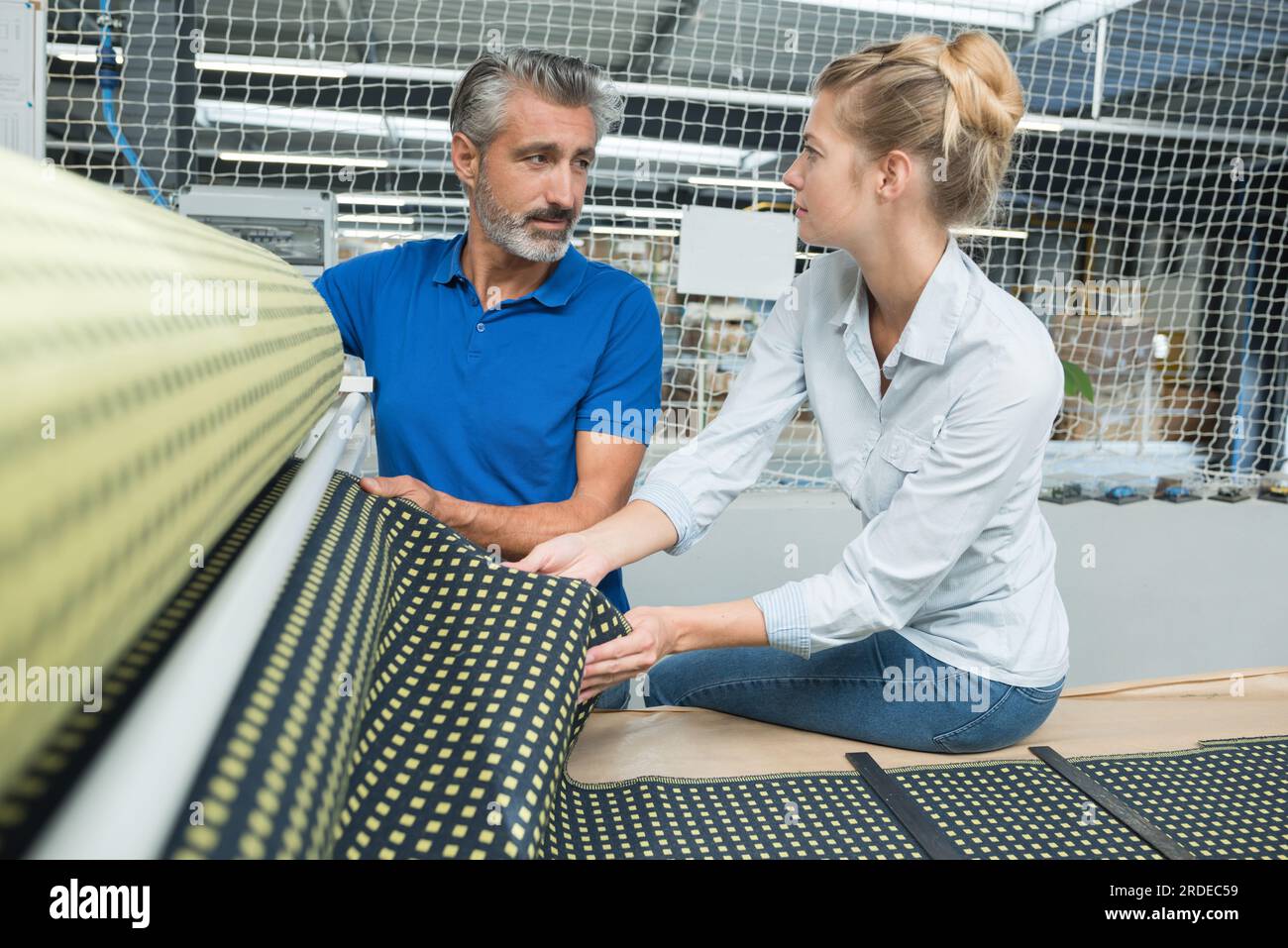 fashion designers doing some work in a textile factory Stock Photo - Alamy