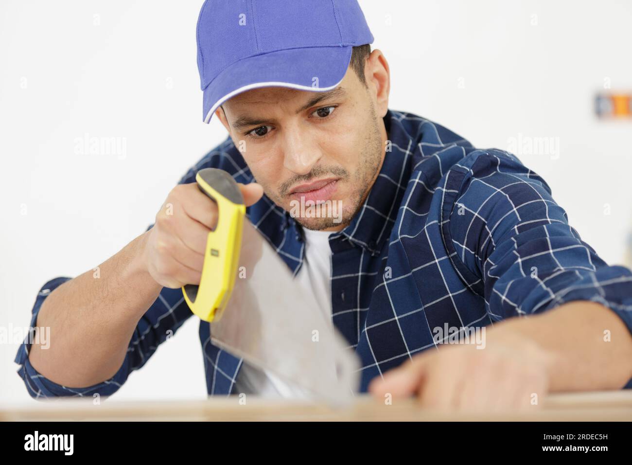 a young man using handsaw Stock Photo - Alamy