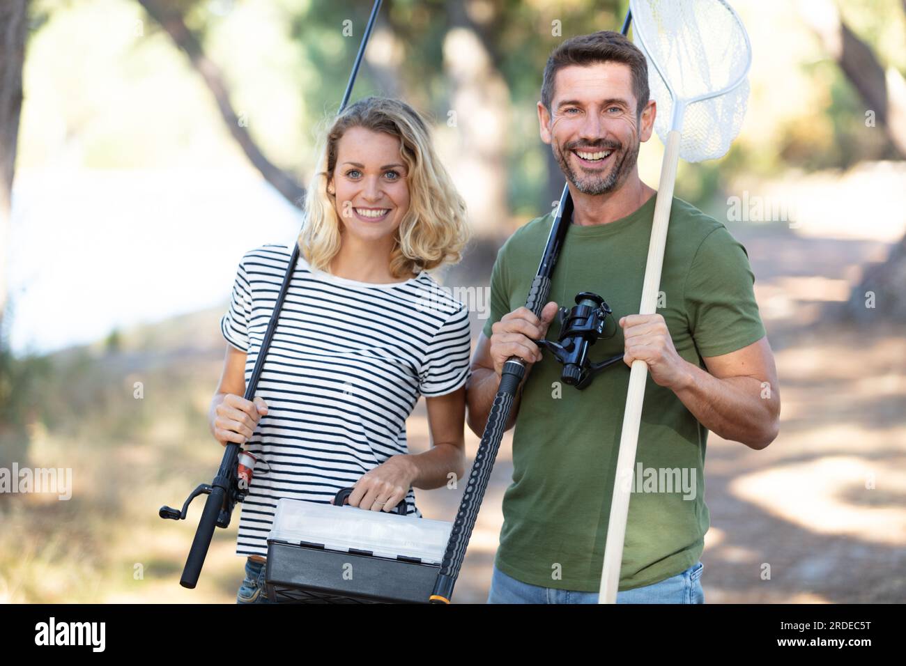 young couple going fishing at the lake Stock Photo - Alamy