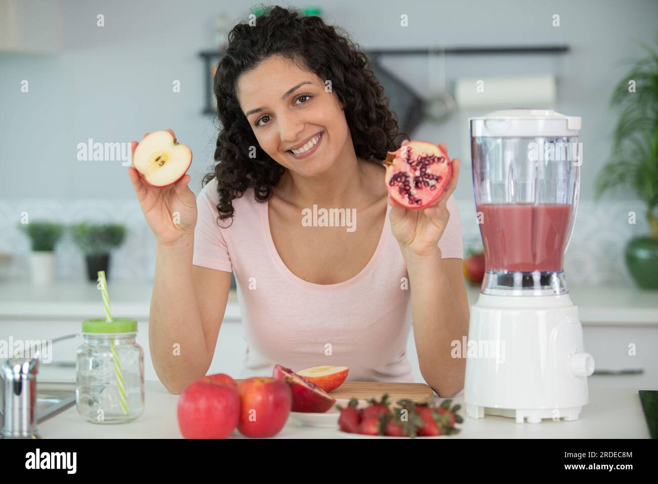 woman showing cut fruit for juicing Stock Photo - Alamy