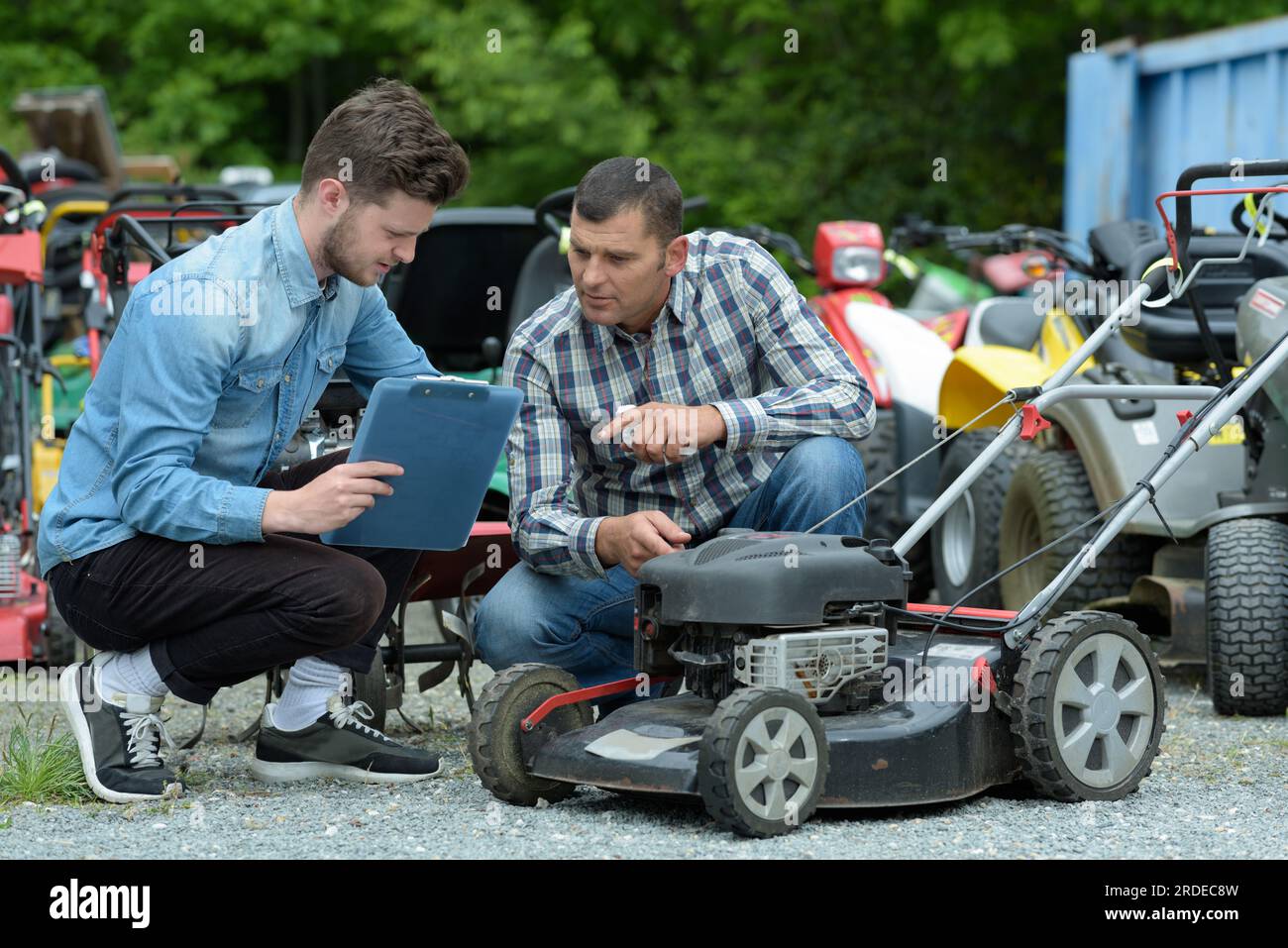portrait of mechanic working with mower Stock Photo - Alamy