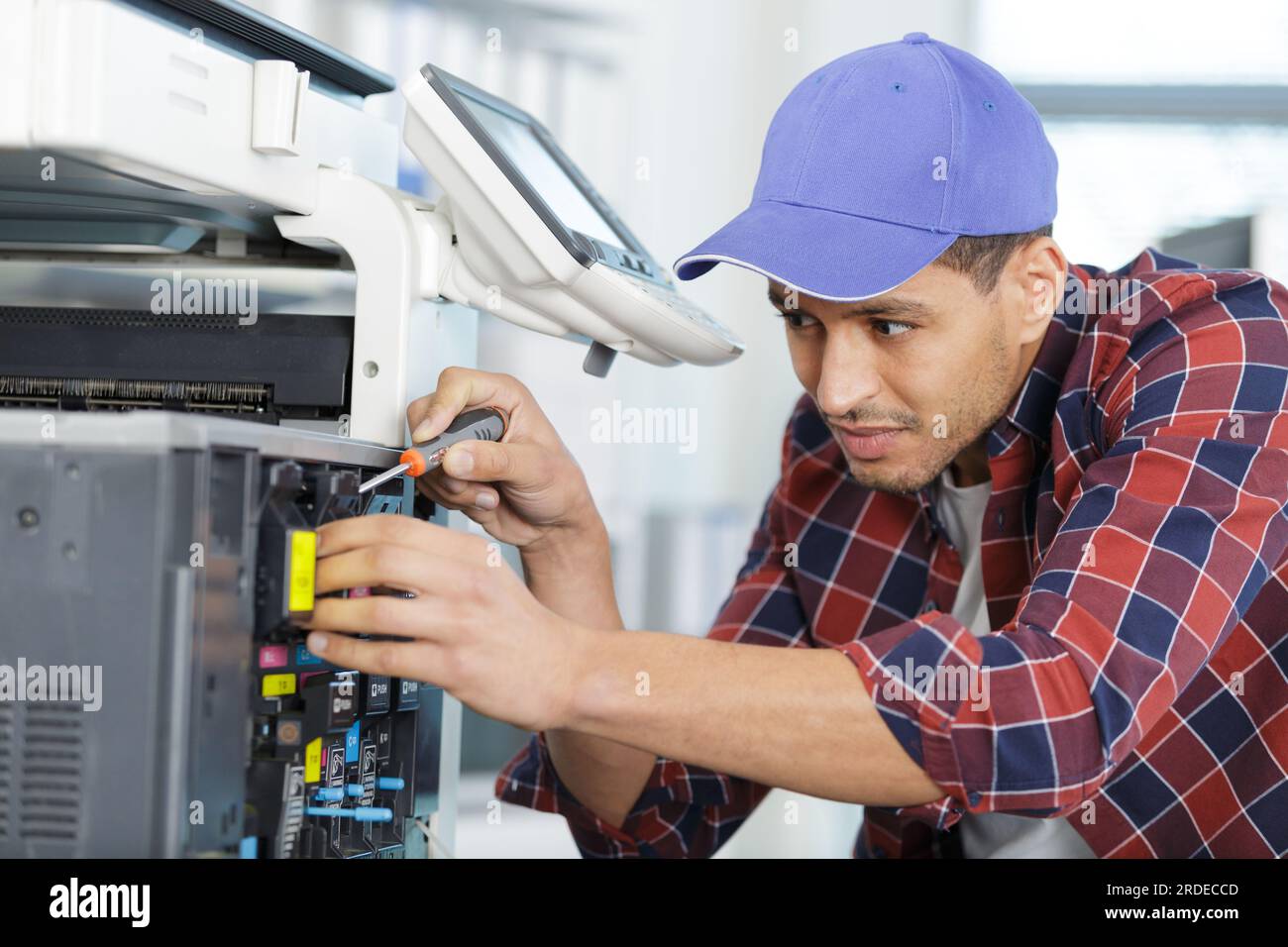 man repairing color printer using a screwdriver Stock Photo - Alamy