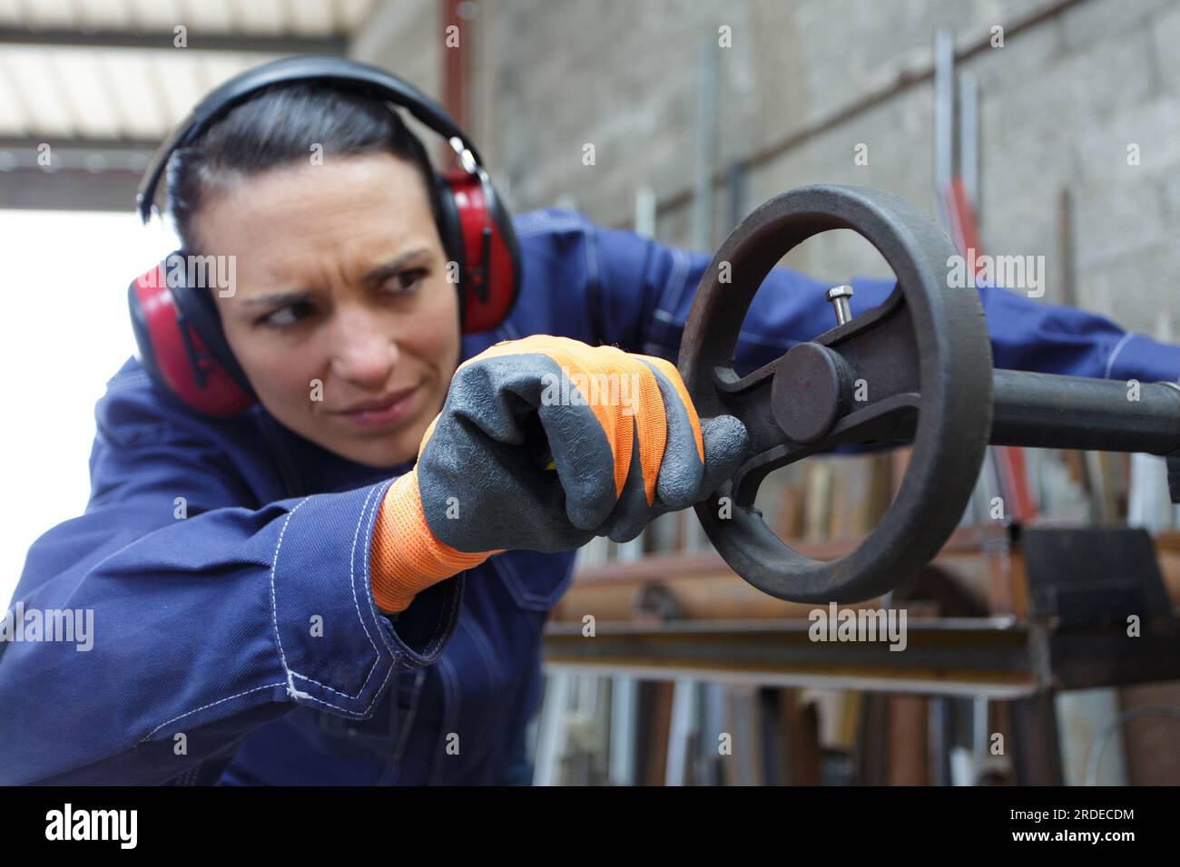 portrait of ordinary efficient female engineer rotating valve inside ...