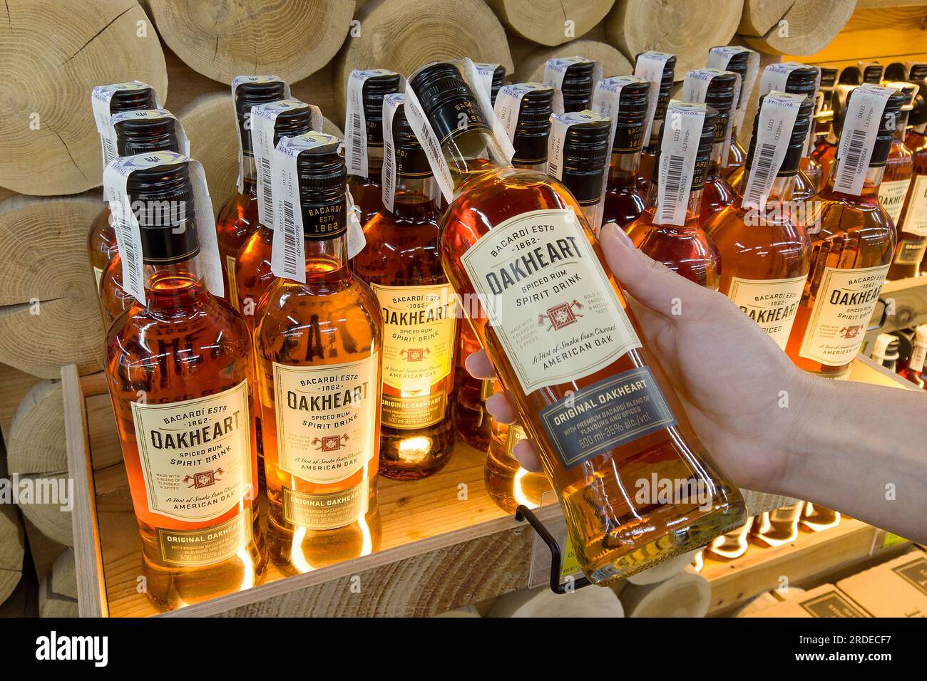 Hand holding Oakheart spiced rum Bacardi 500 ml rum bottle in a ...