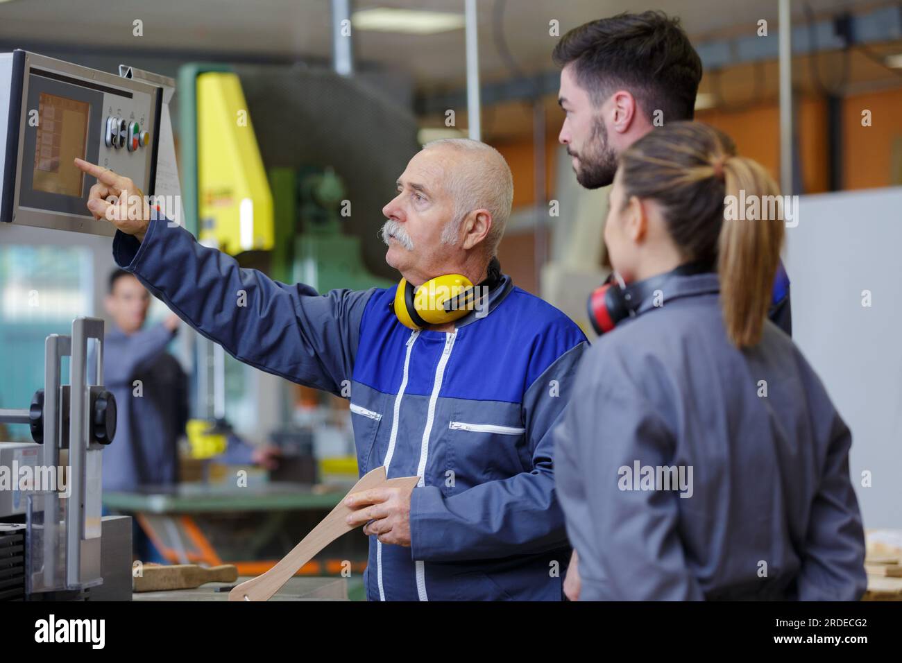 apprentice learning to use a machine Stock Photo - Alamy