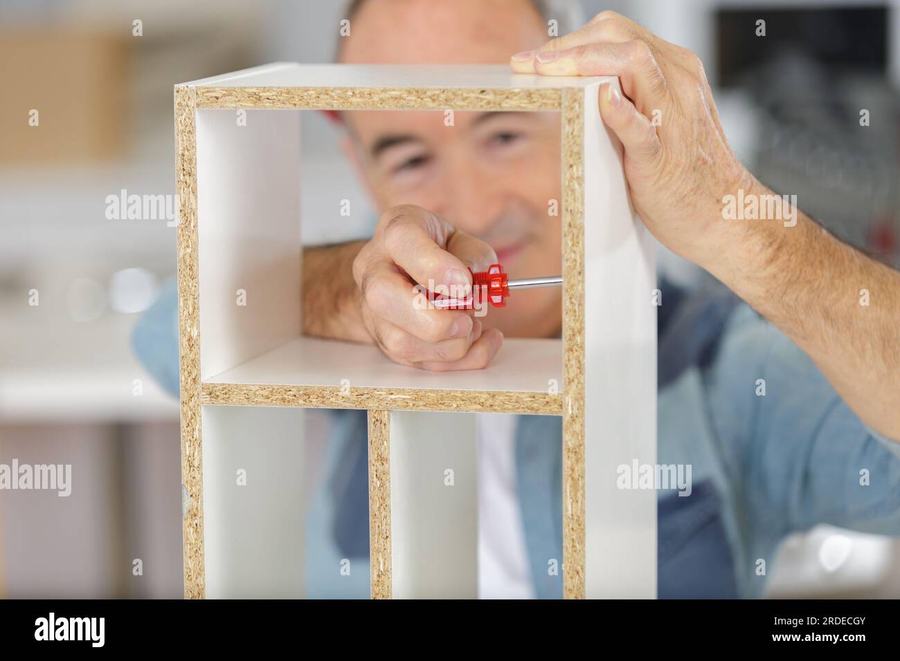 Person assembling flat pack hi-res stock photography and images - Alamy