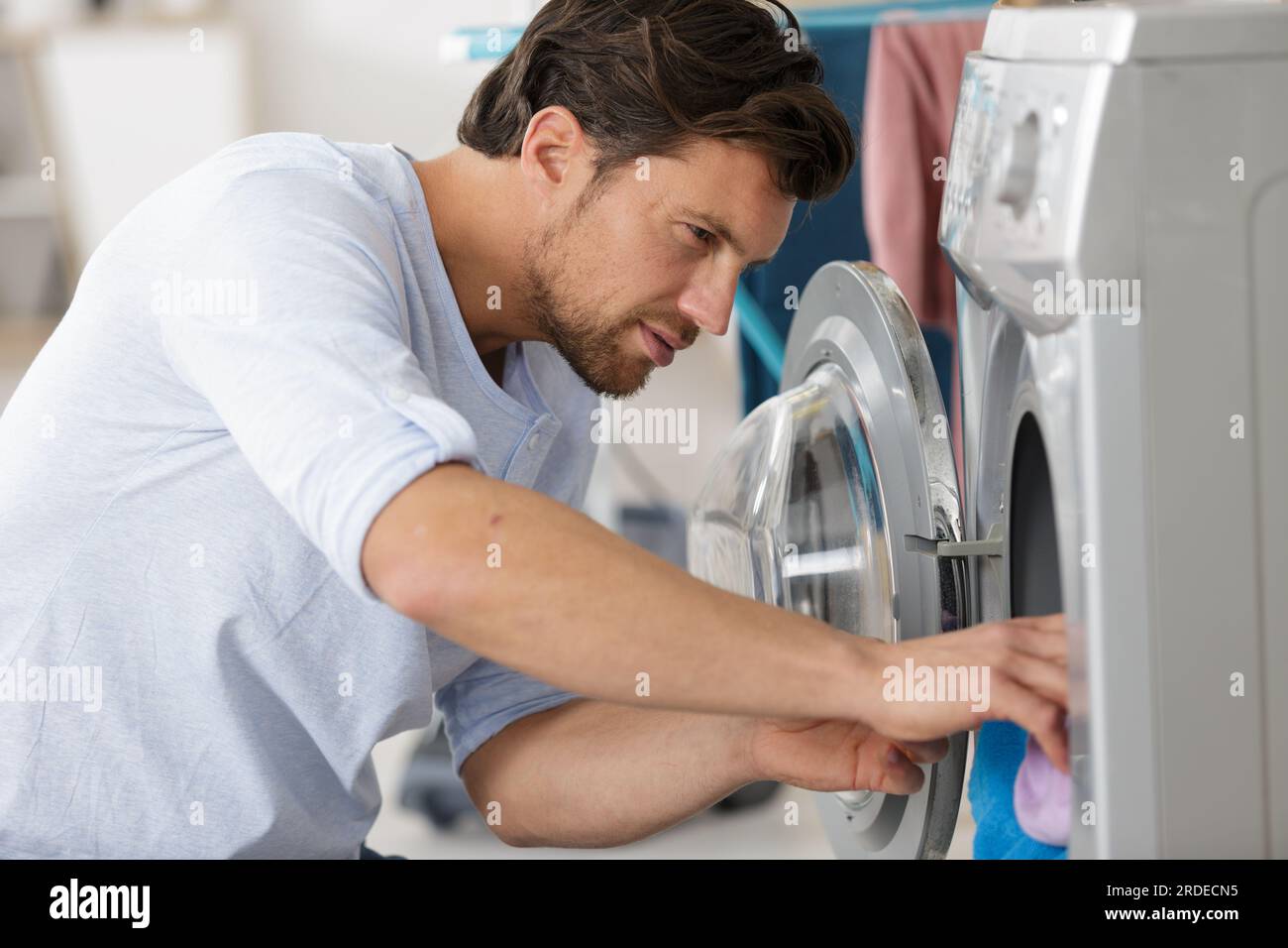 Person doing laundry home folding hi-res stock photography and images ...