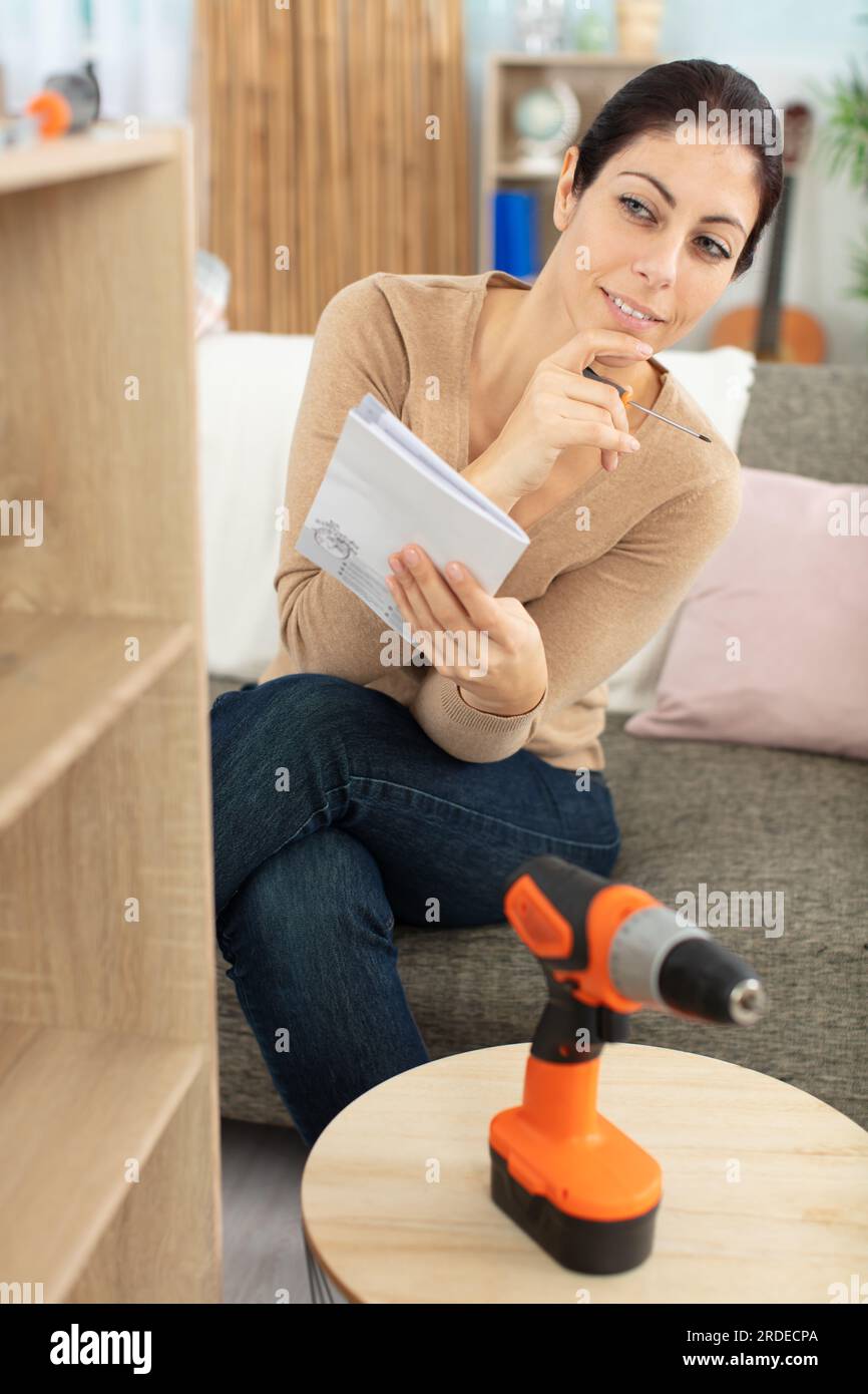 woman working on a new installation using a cordless drill Stock Photo ...
