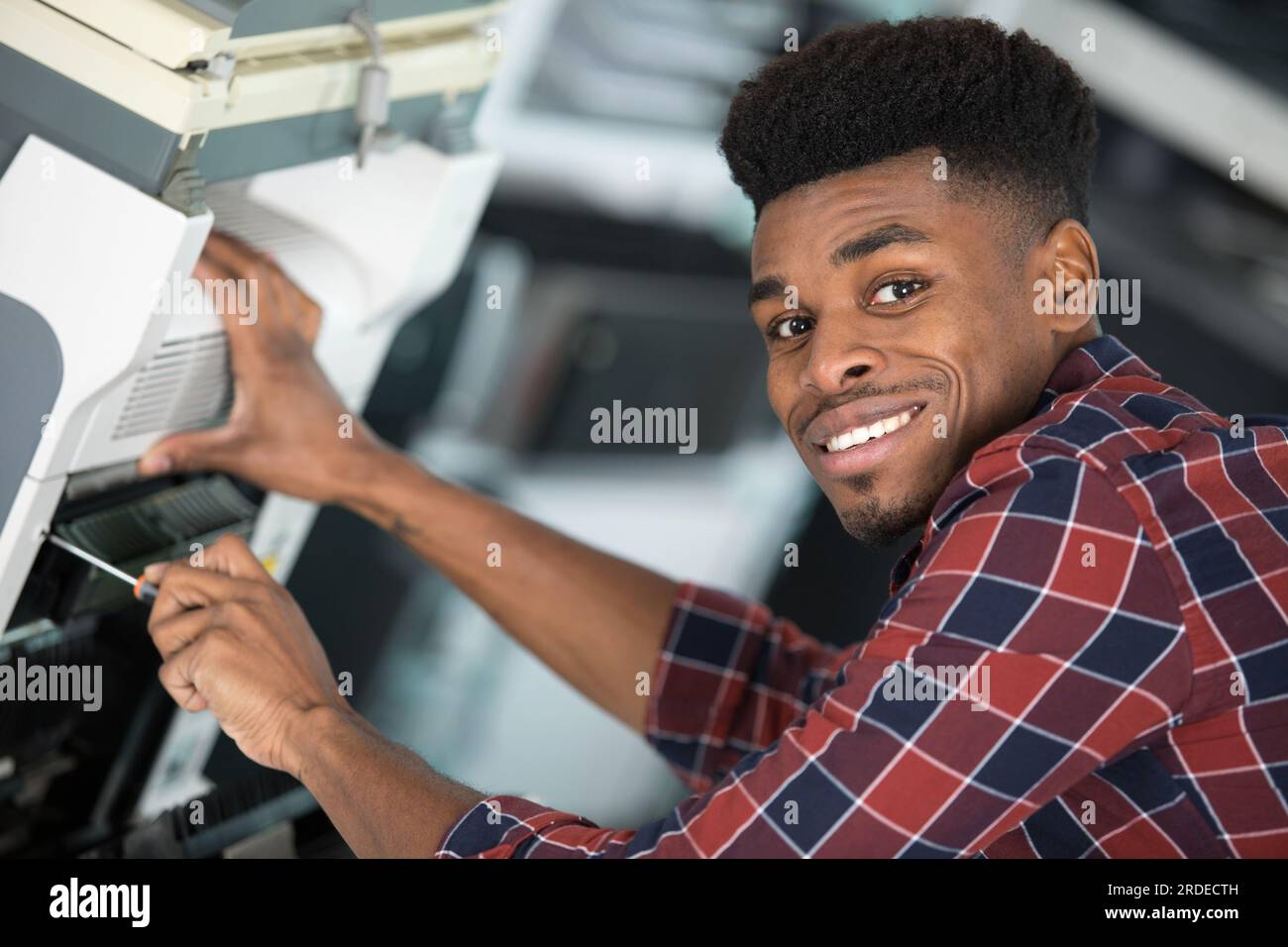 repairman working on a printer Stock Photo - Alamy