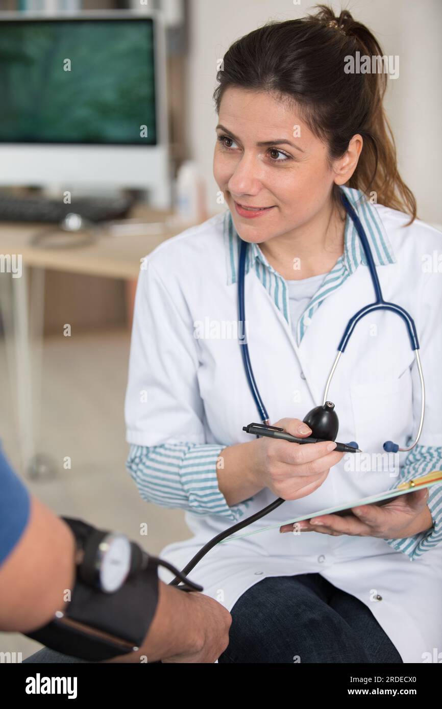 female doctor taking blood pressure Stock Photo - Alamy
