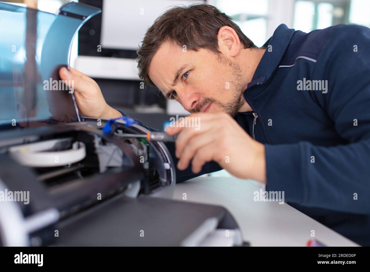 man is fixing a printer Stock Photo - Alamy