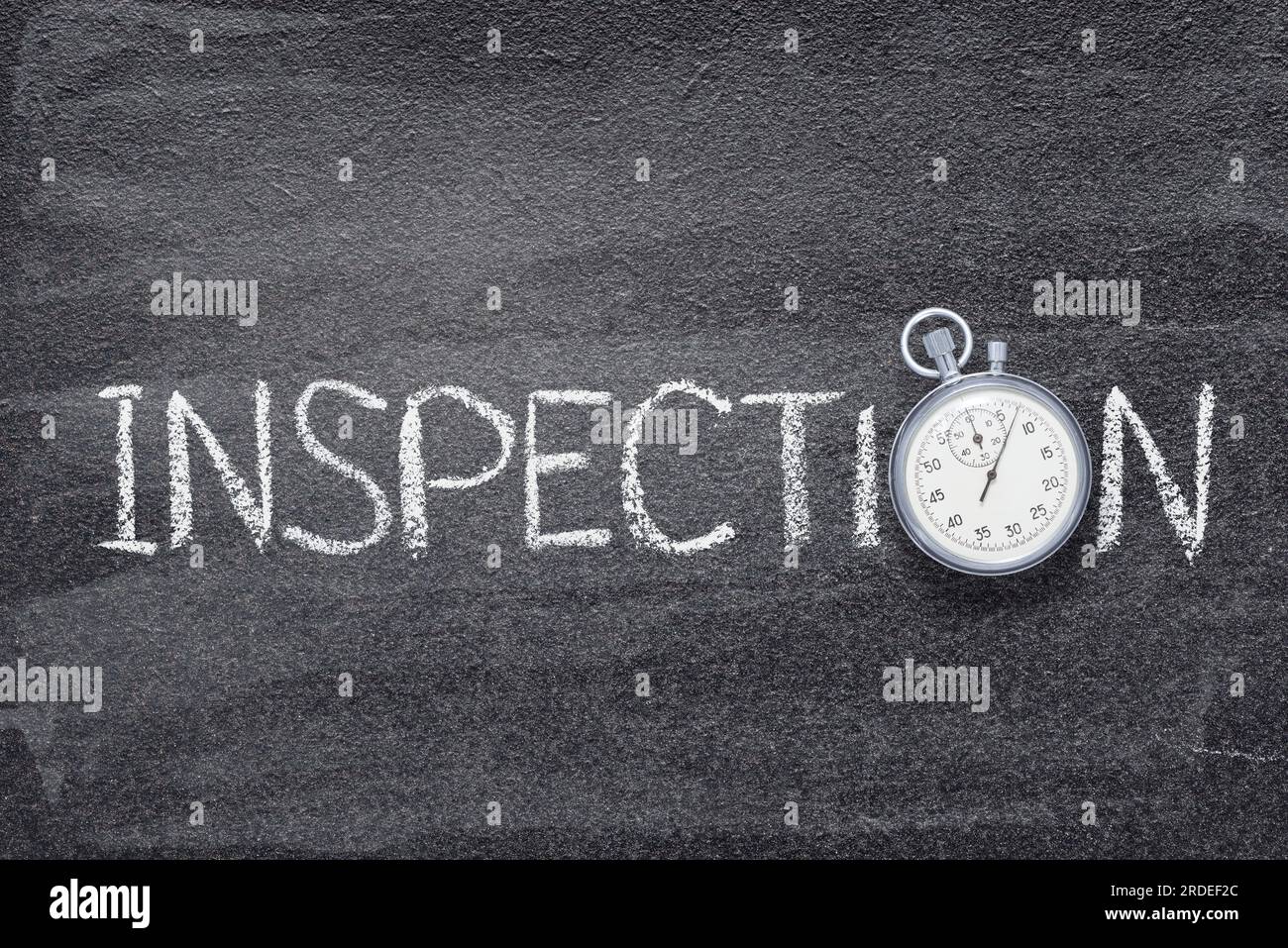 inspection word written on chalkboard with vintage precise stopwatch ...
