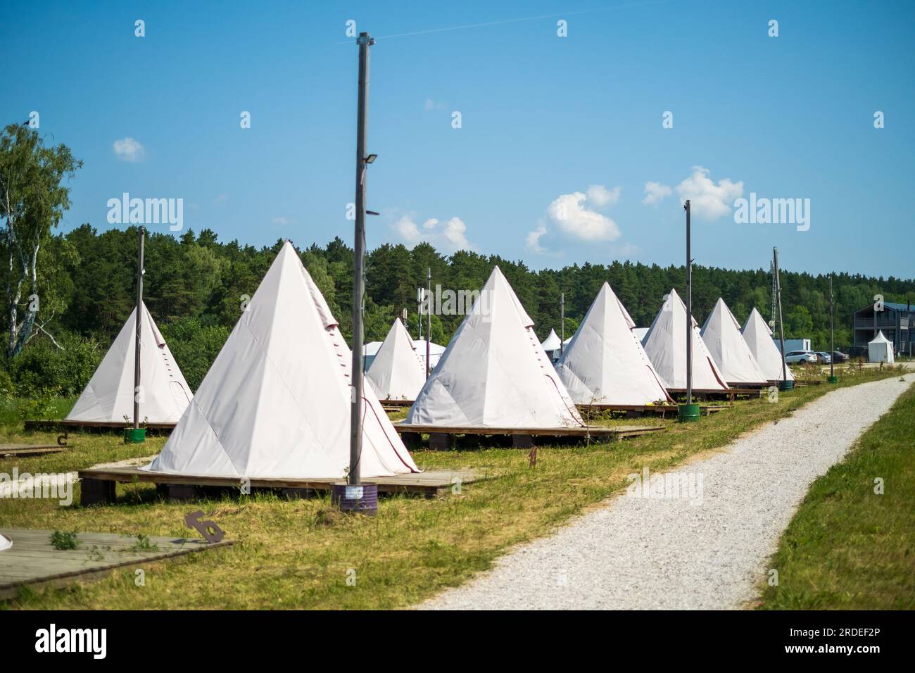 Set up rows of white tents in campsite of festival ready for event ...