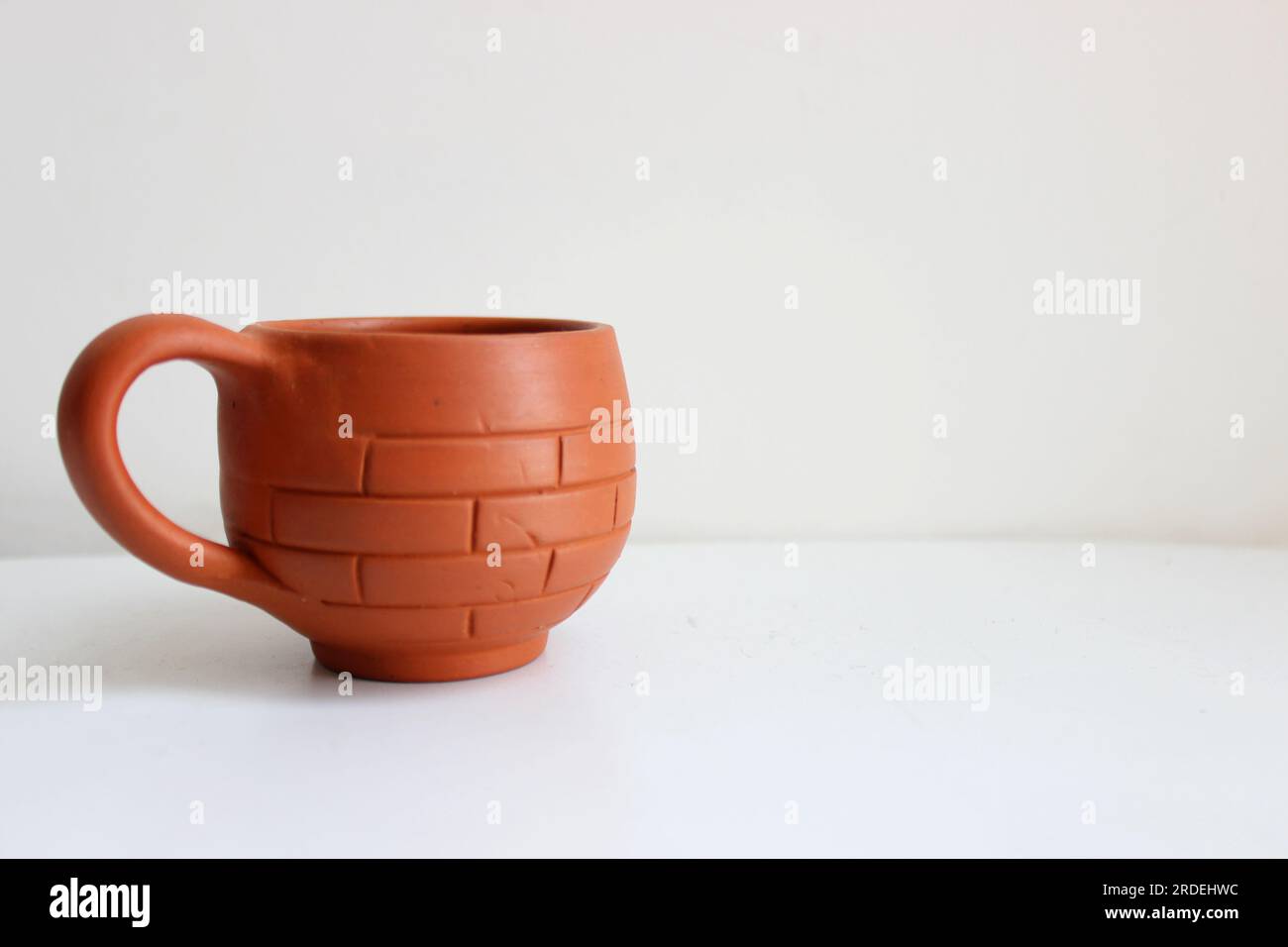 Tea cup made of red soil placed isolated. brick style pattern on the ...