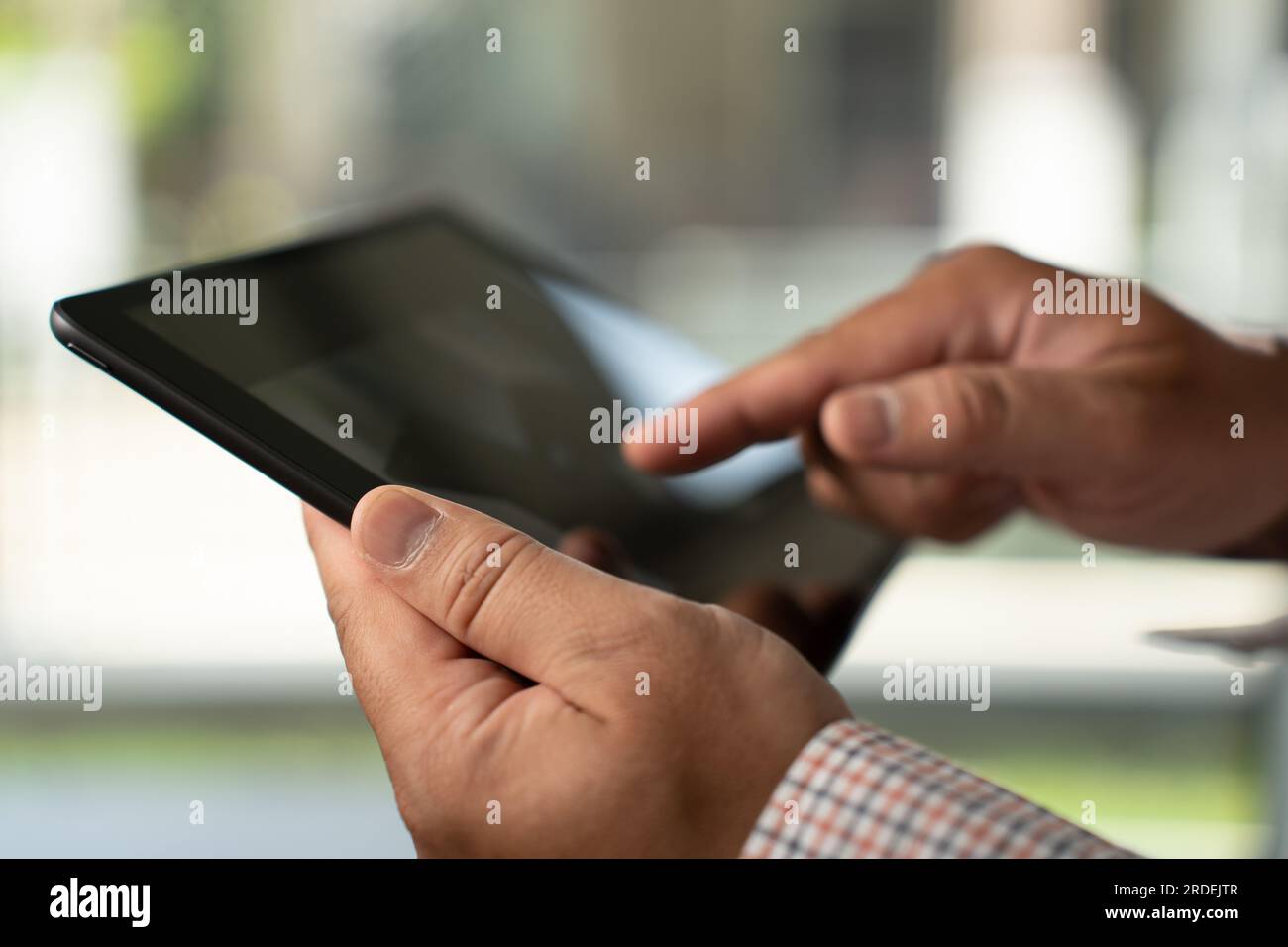 Man hands using looking and touch tablet laptop and cellphone ...