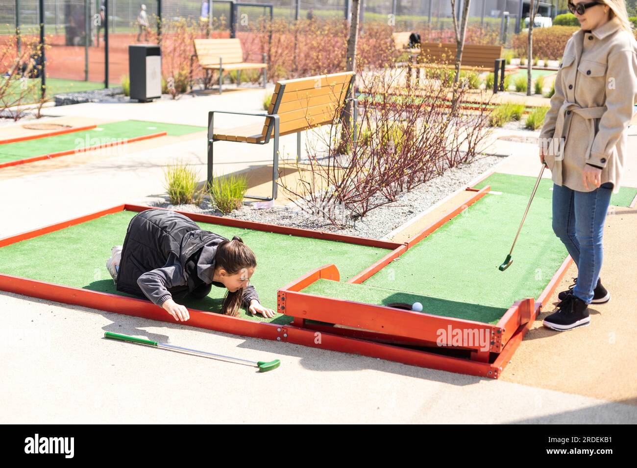 Family Time Playing Mini-Golf In The Summer Stock Photo - Alamy