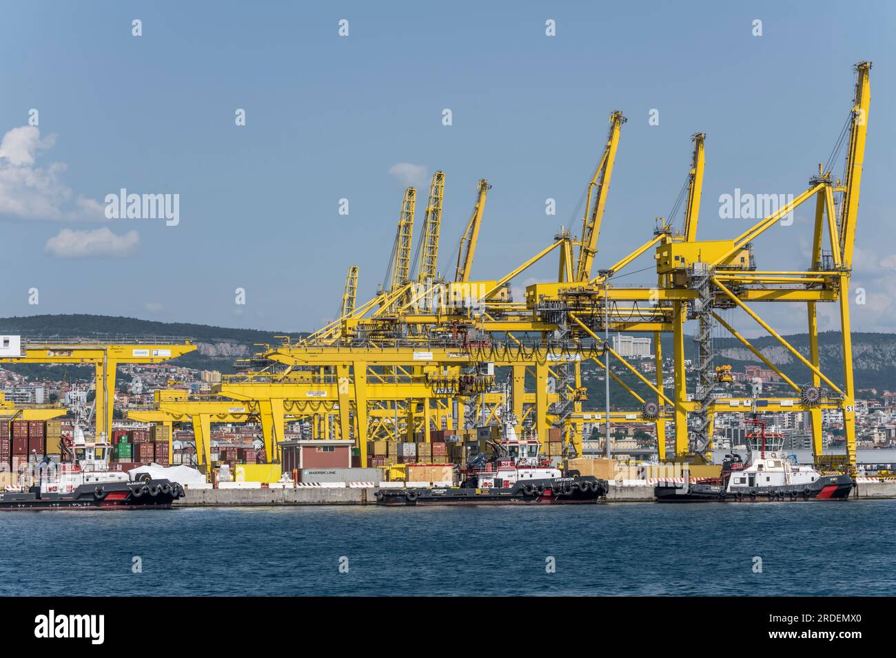 TRIESTE, ITALY - may 29 2023: cityscape with big cranes and tug-boats ...