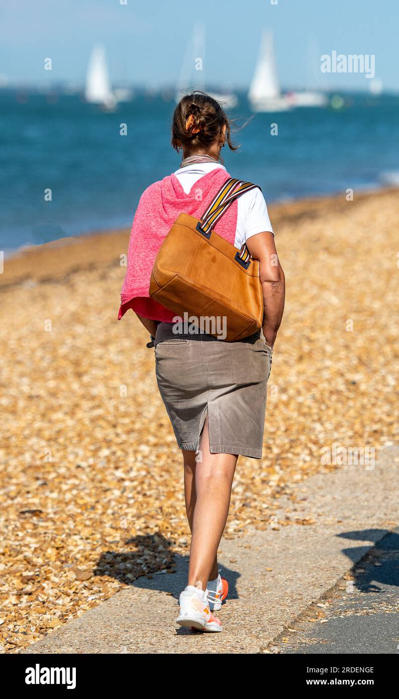 stylish middle-aged lady walking along the seafront at cowes on the ...