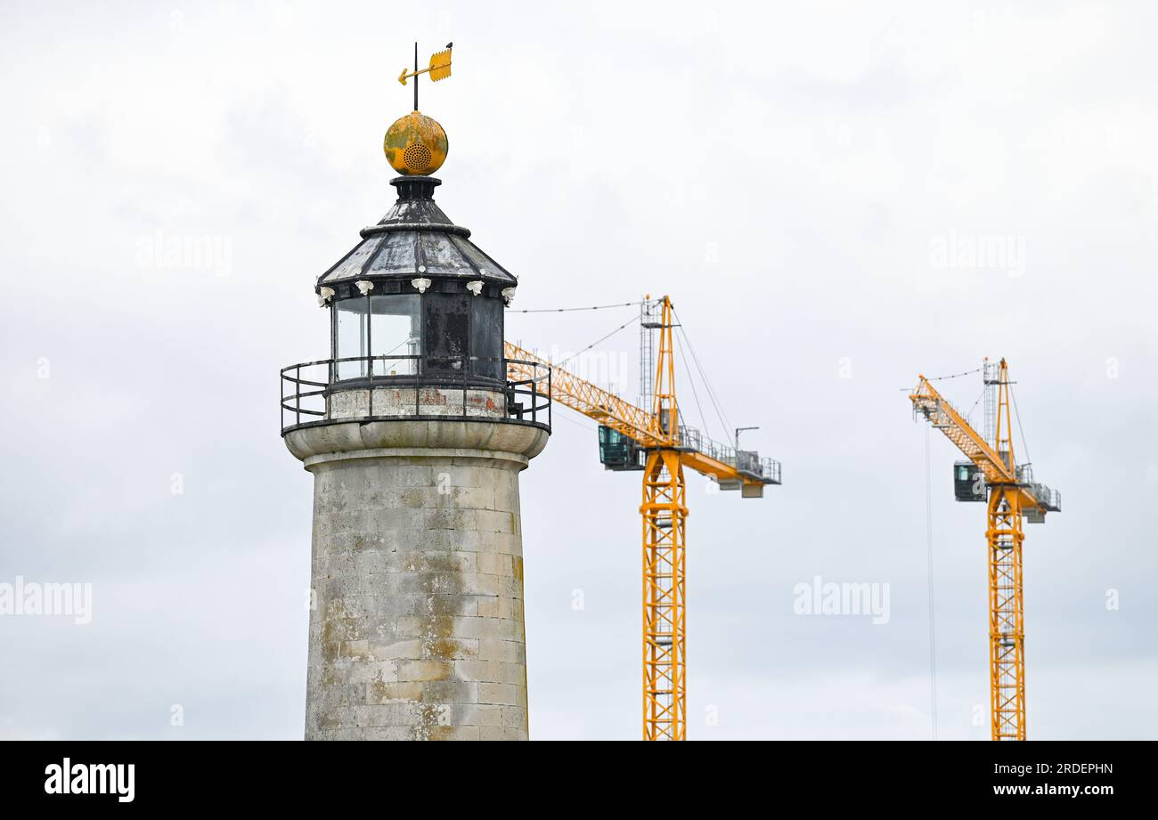 Shoreham Lighthouse with cranes from a nearby building construction ...