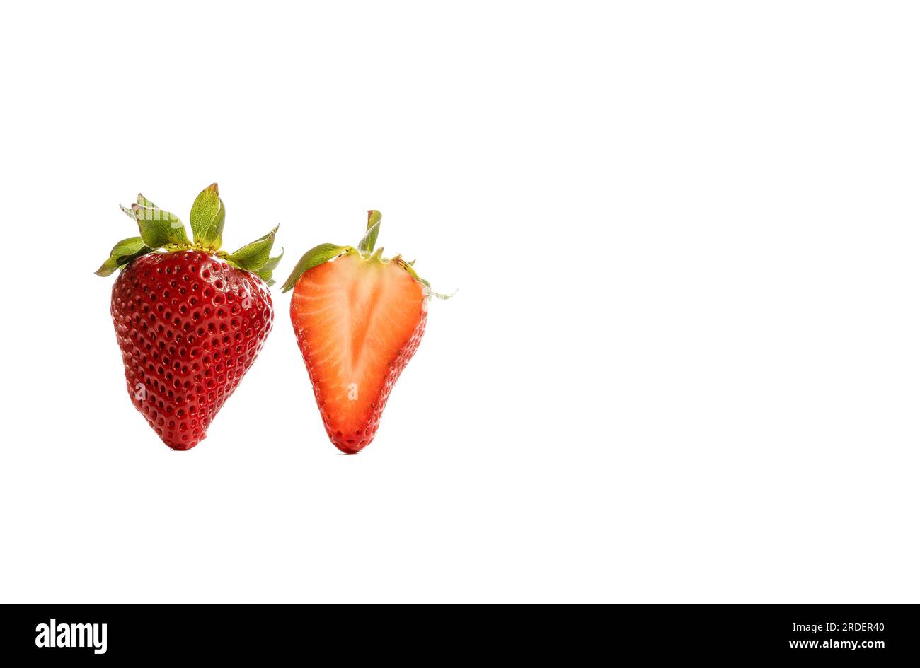 Closeup of a fresh strawberry cut in half isolated on white background ...
