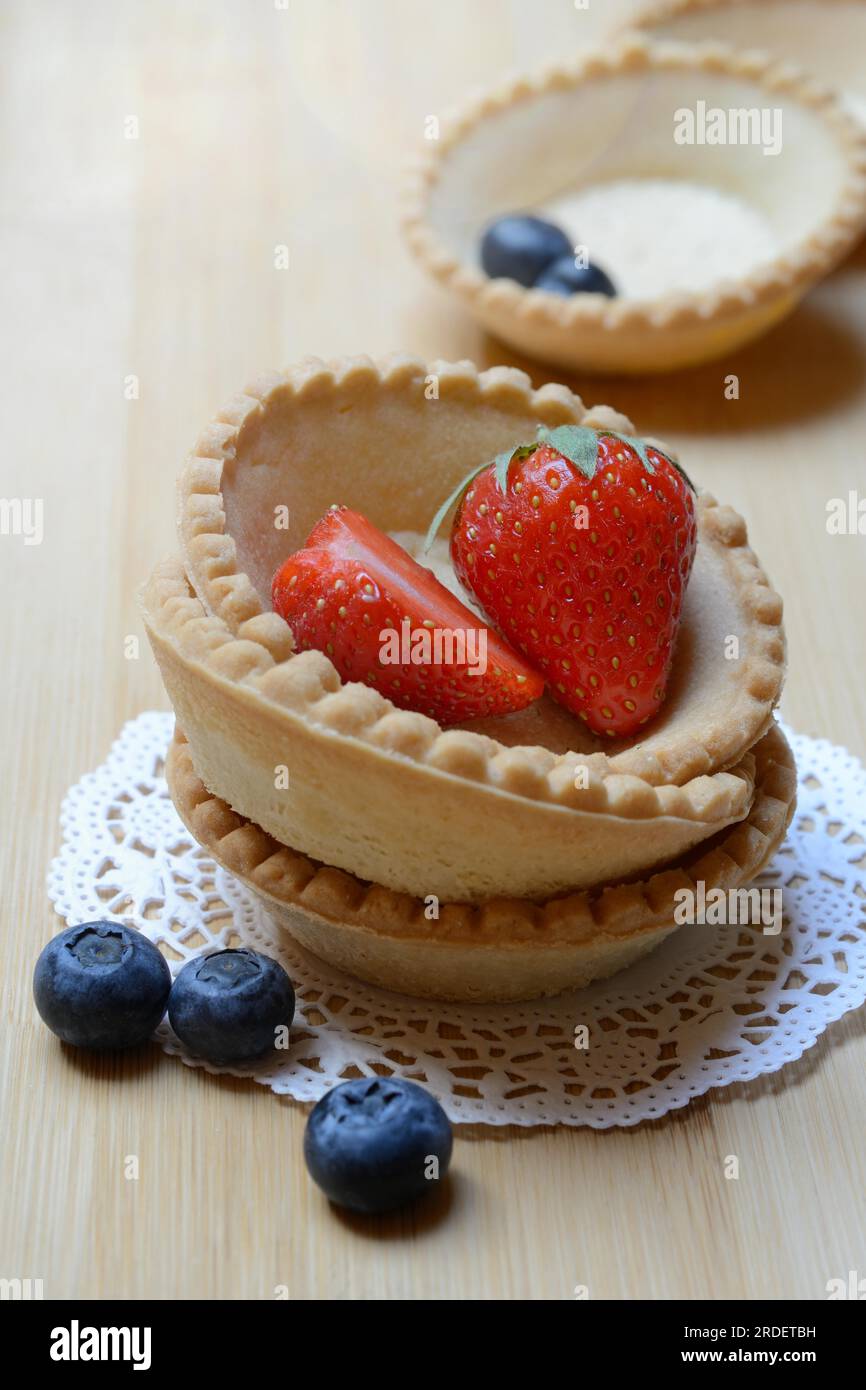 Tartelette, pre-made tartlet base with strawberry and blueberries Stock ...