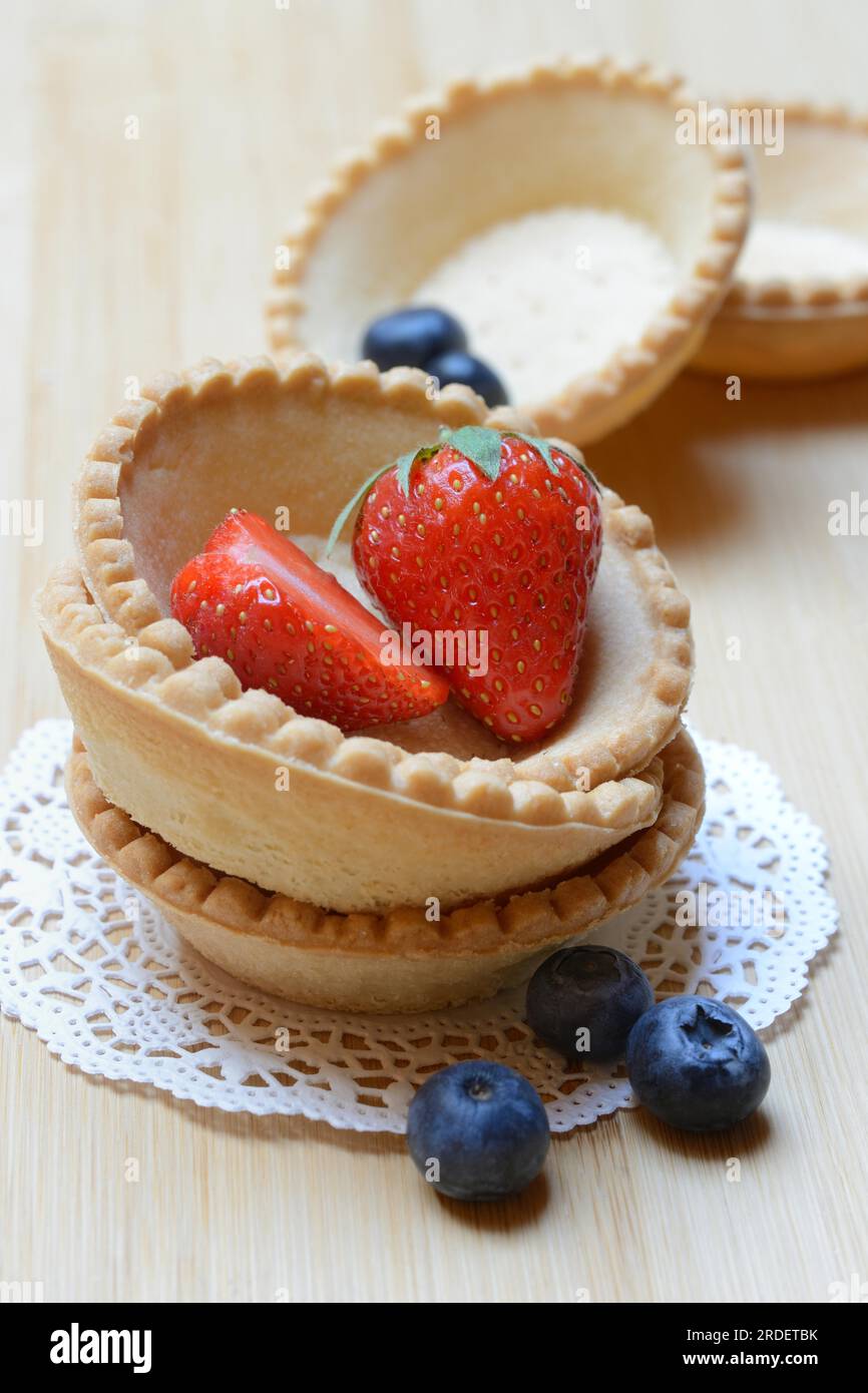 Tartelette, pre-made tartlet base with strawberry and blueberries Stock ...