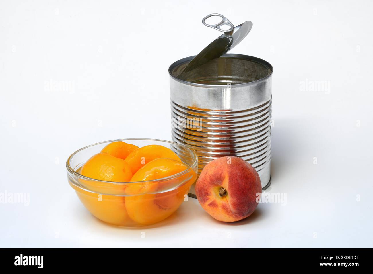 Peach, pickled peach halves in glass bowl and tin can Stock Photo - Alamy