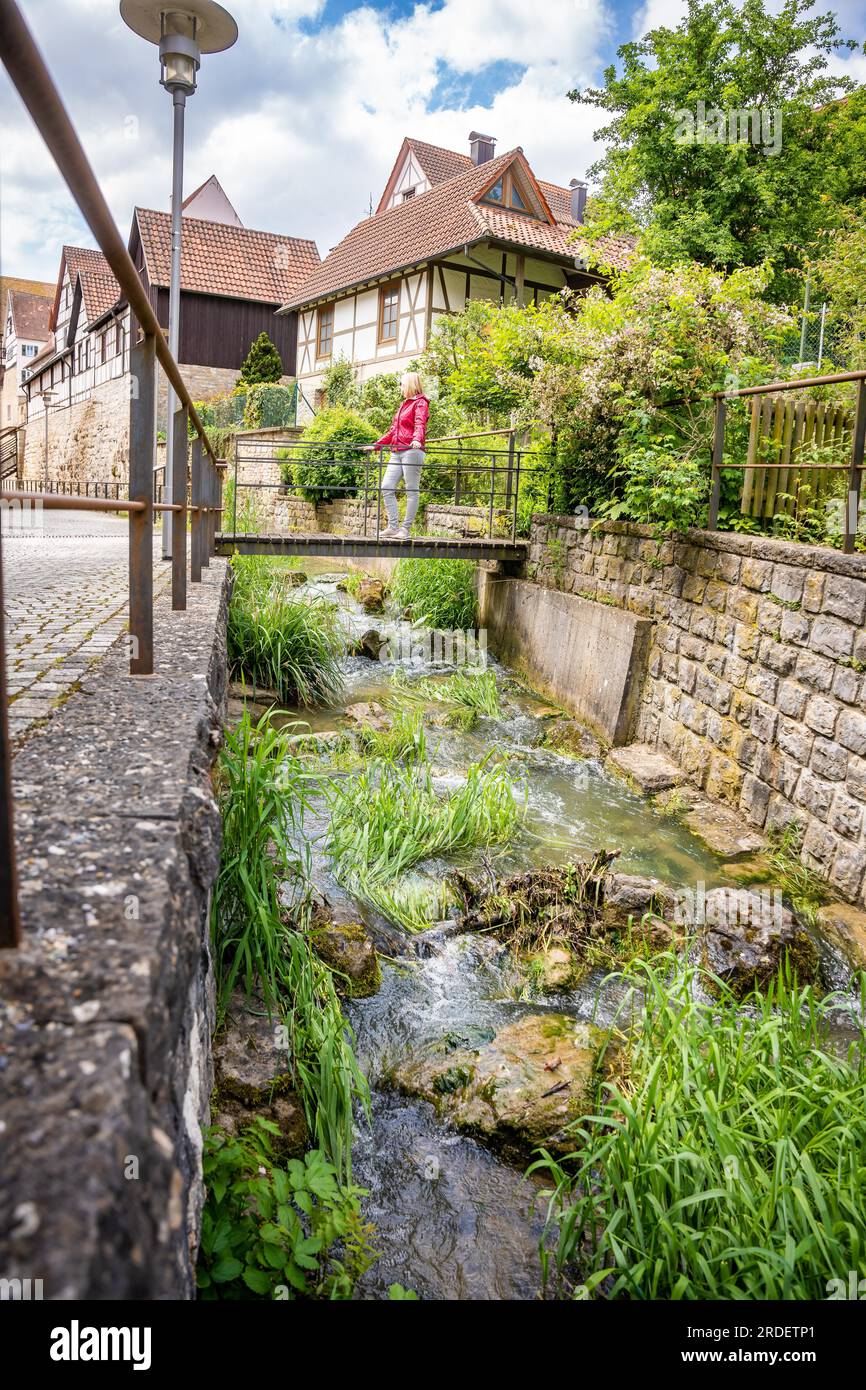 Small bridge in the town centre with woman in red jacket, Balingen ...