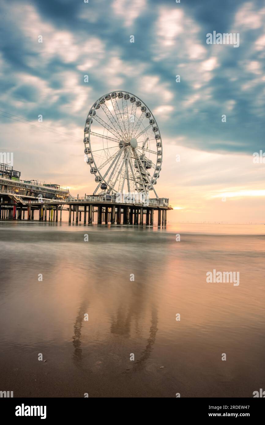 Ferris wheel at sunset on the pier at the beach, The Hague, Netherlands ...