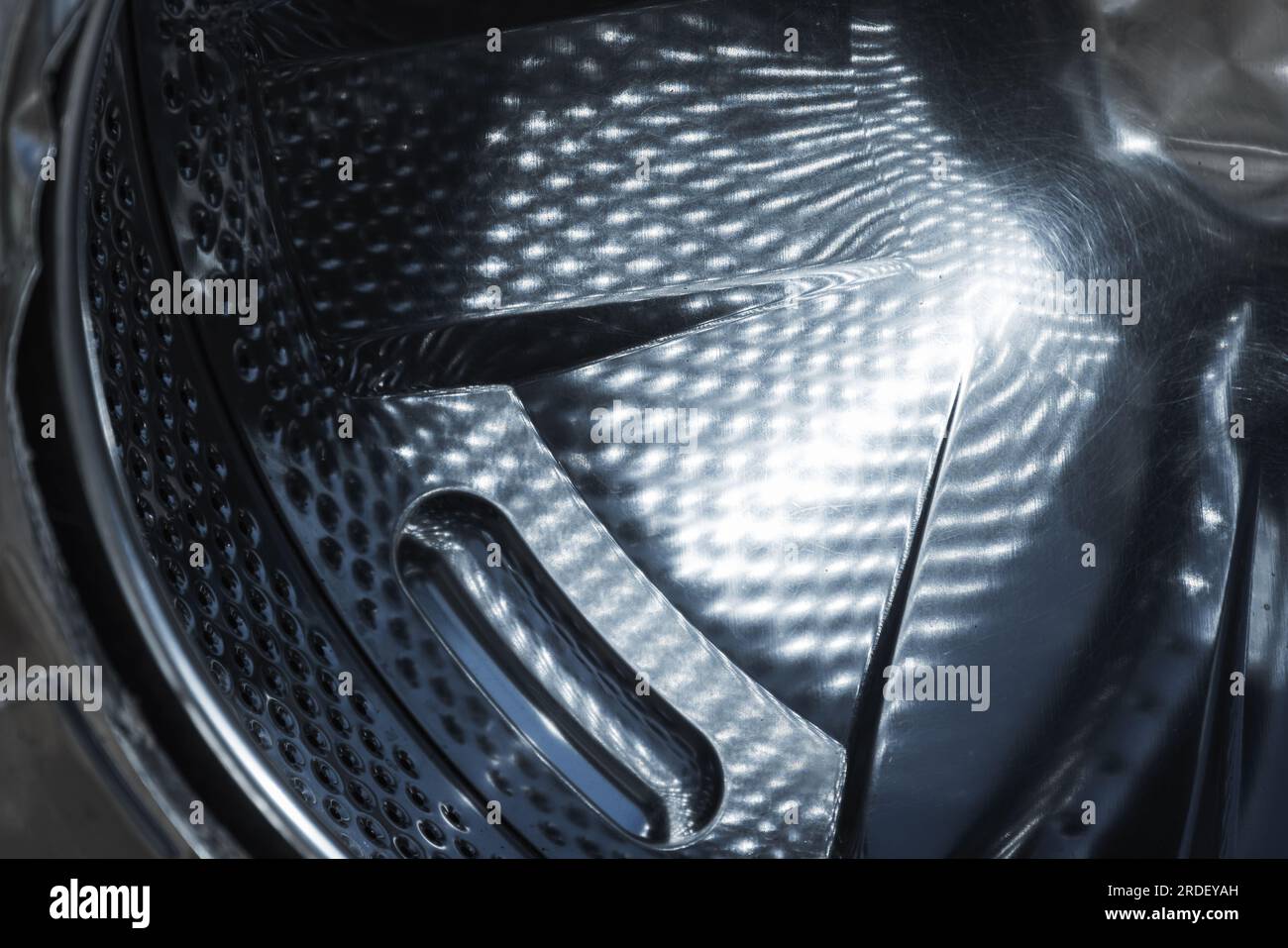 Shiny washing machine drum made of stainless steel, abstract industrial ...