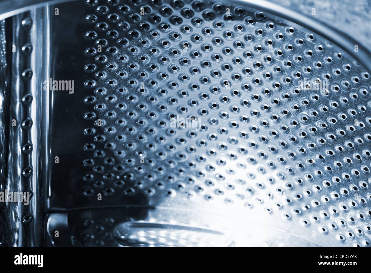 Used washing machine drum made of stainless steel, abstract industrial ...