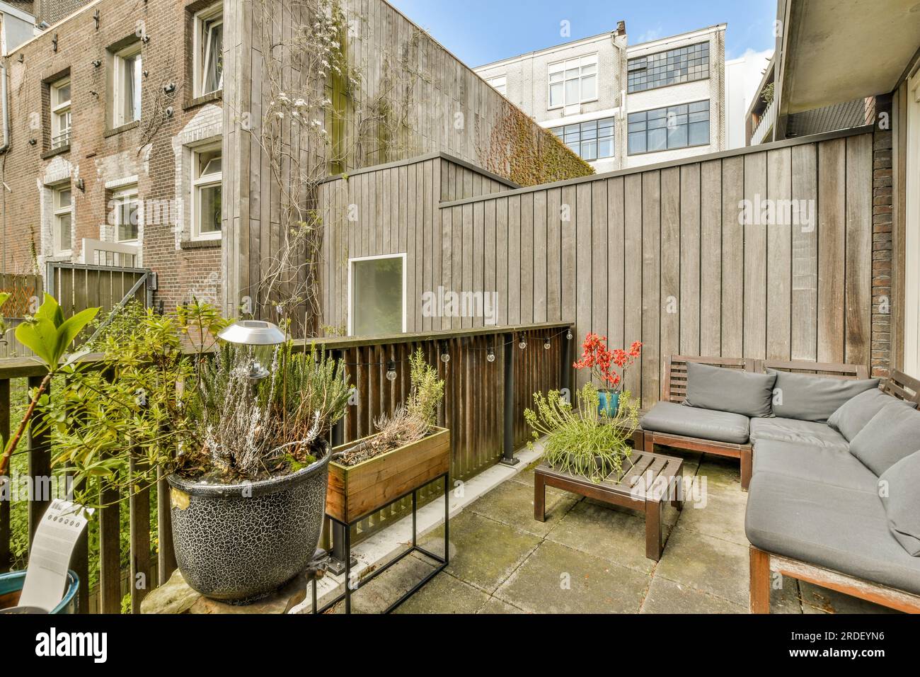 an outside area with furniture and plants in the fore - image is taken ...