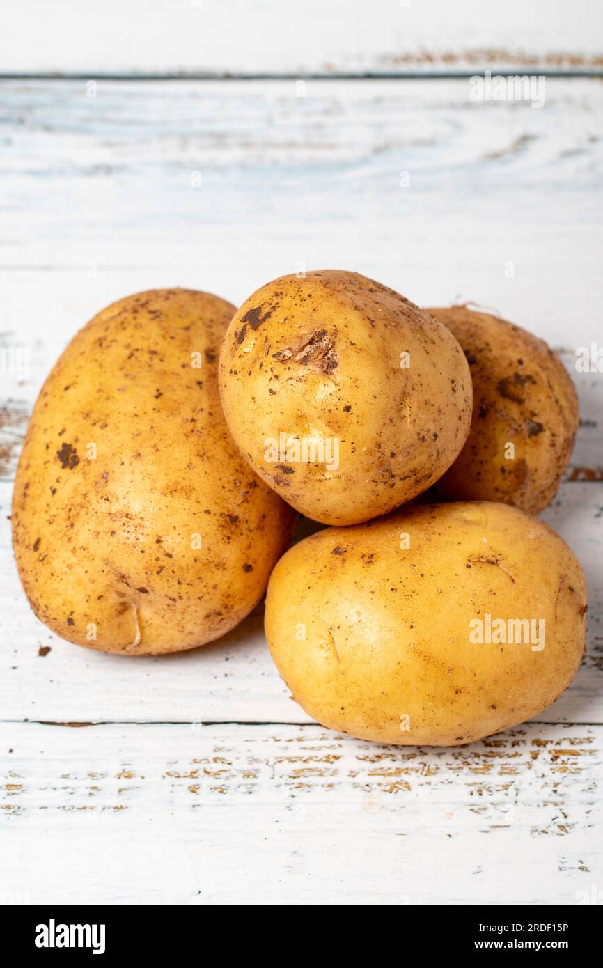 Potatoes on a white wood background. Fresh raw potato harvest season ...