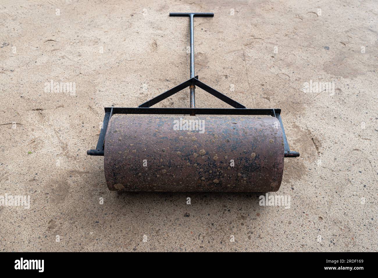 Rolling yellow sand with a steel roller for a garden pool Stock Photo ...