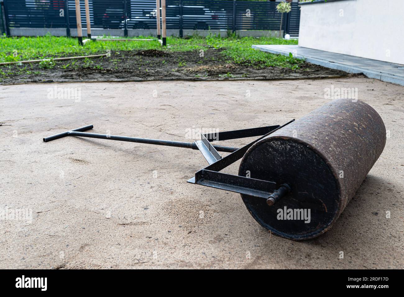 Rolling yellow sand with a steel roller for a garden pool Stock Photo ...