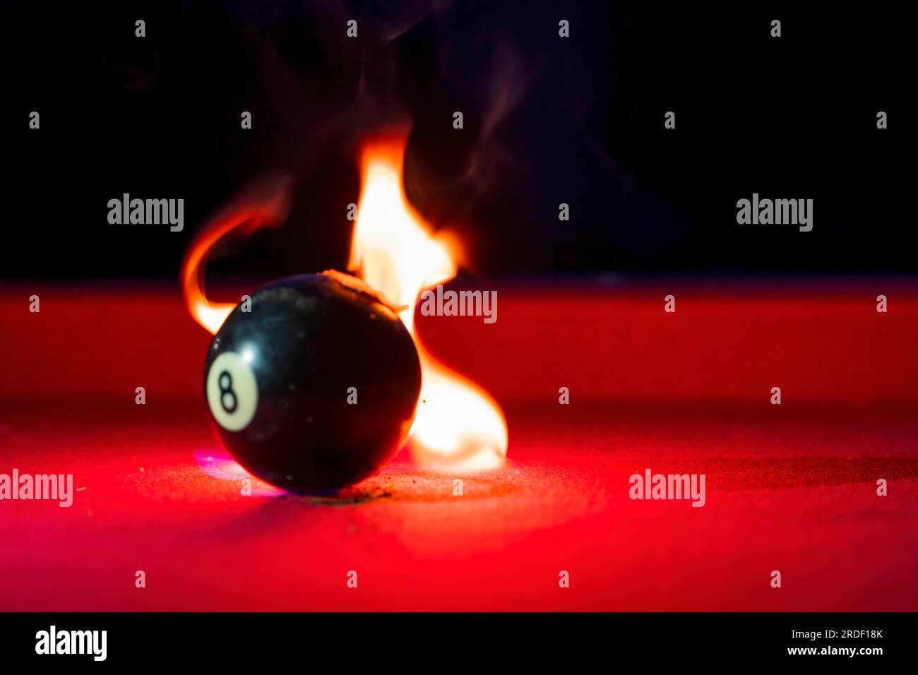 Billiard balls are photographed on fire while sitting outdoors in an ...