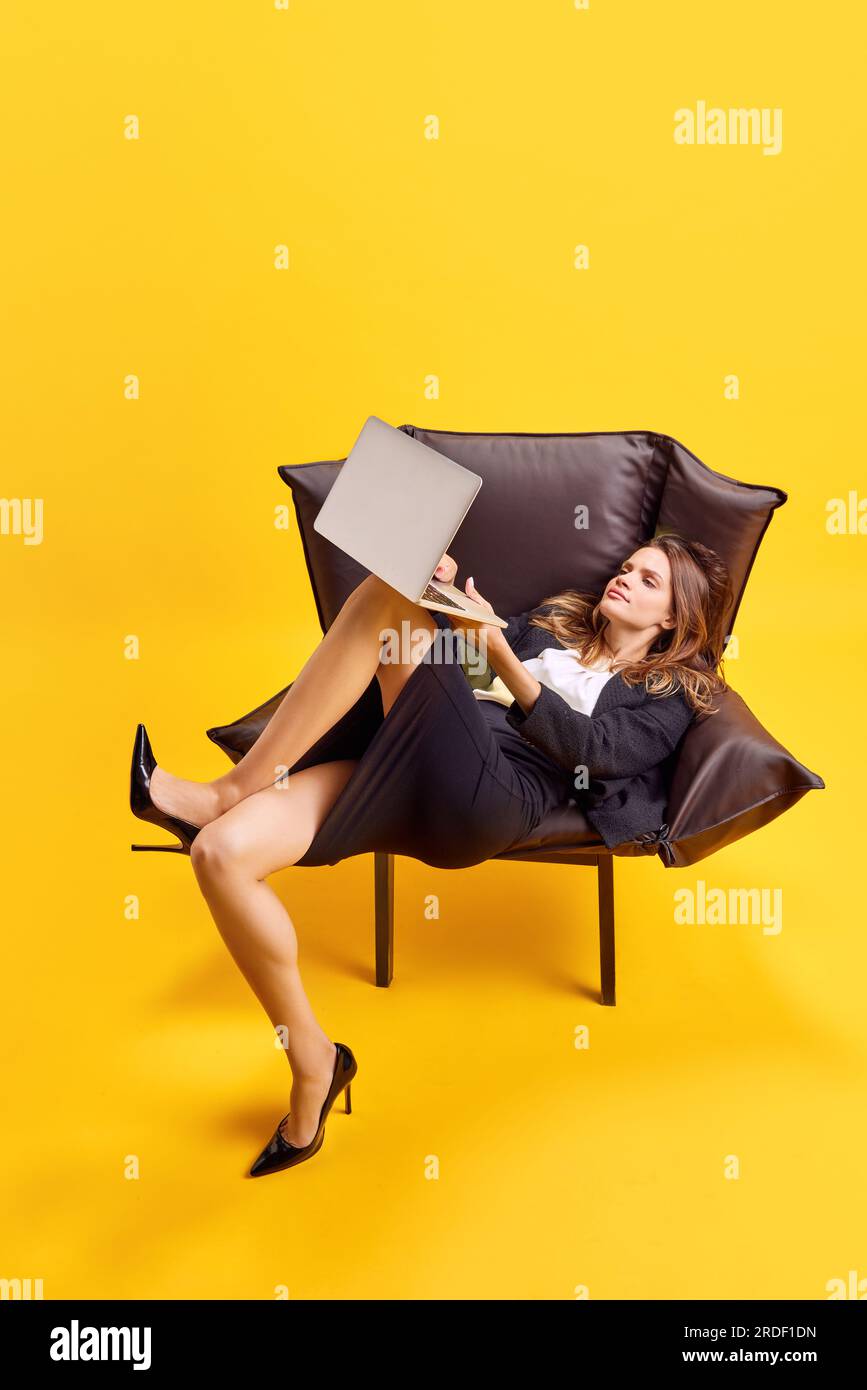 Business woman sitting in weird uncomfortable position armchair and ...