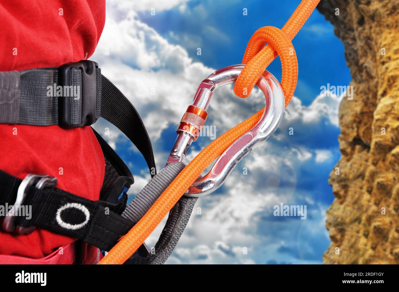 climber climbing a rope on a rock Stock Photo - Alamy