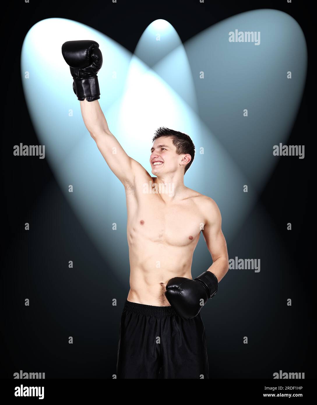 happy boxer winner under the rays of spotlight Stock Photo - Alamy