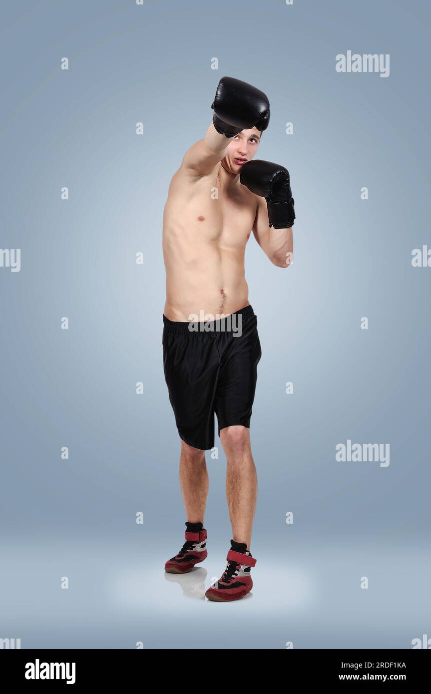 young muscular boxer wearing boxing black gloves Stock Photo - Alamy
