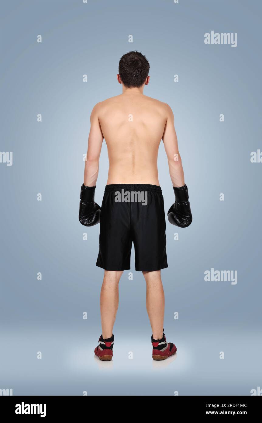 boxer standing with his back under the spotlight Stock Photo - Alamy